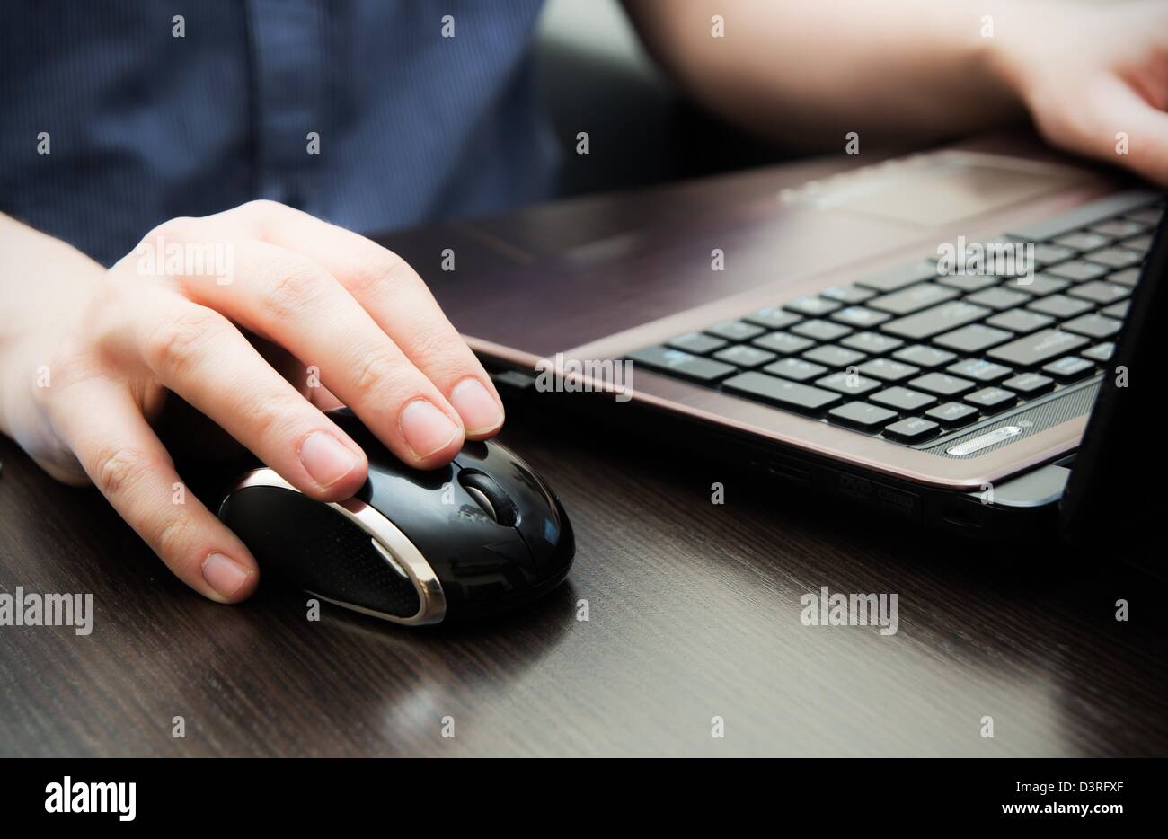 Human hand on computer mouse. Laptop on desk Stock Photo - Alamy