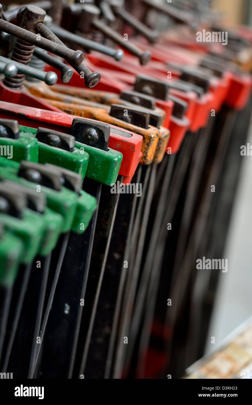 Some colored iron tools in a factory Stock Photo - Alamy