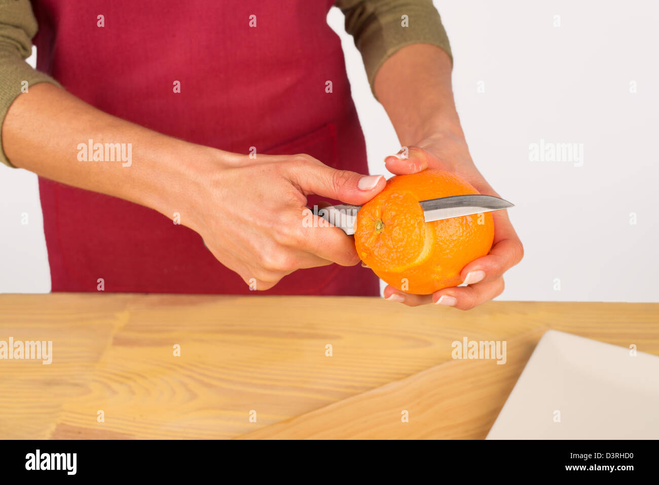 Female hands peeling a fresh orange Stock Photo - Alamy
