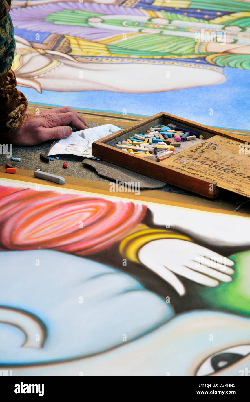 Street artist drawing colourful chalk paintings on the pavement Stock ...