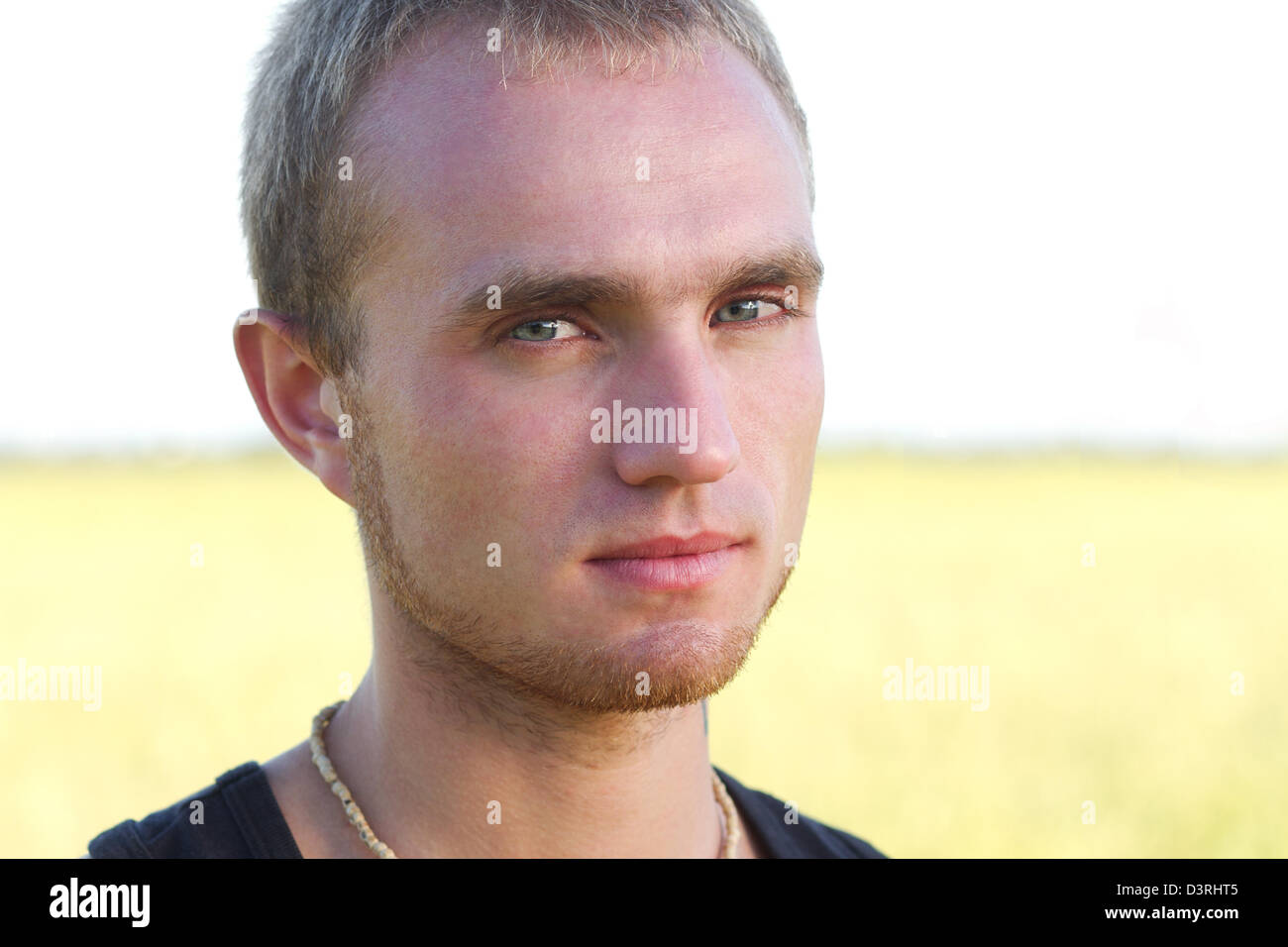 Serious young man with beard looking at you Stock Photo - Alamy