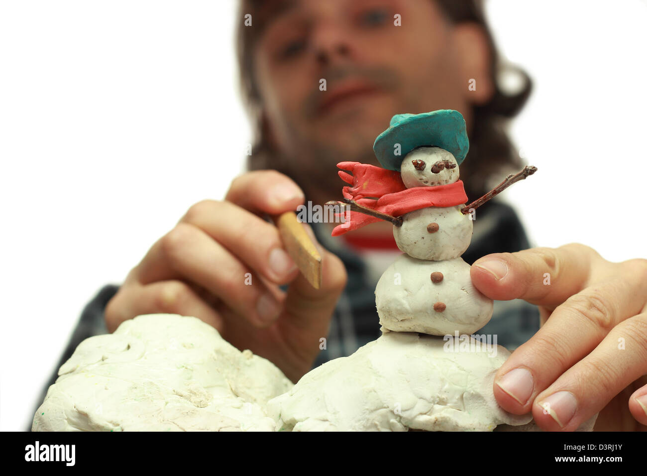traditional clay animator at work on snowman miniature Stock Photo - Alamy