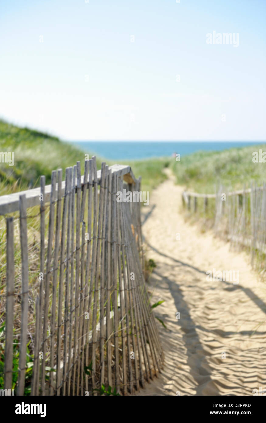 Sandy beach path and fence leading to the ocean, Jetties Beach ...