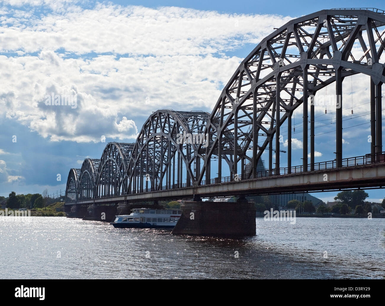 Railroad bridge and boat on river Stock Photo - Alamy