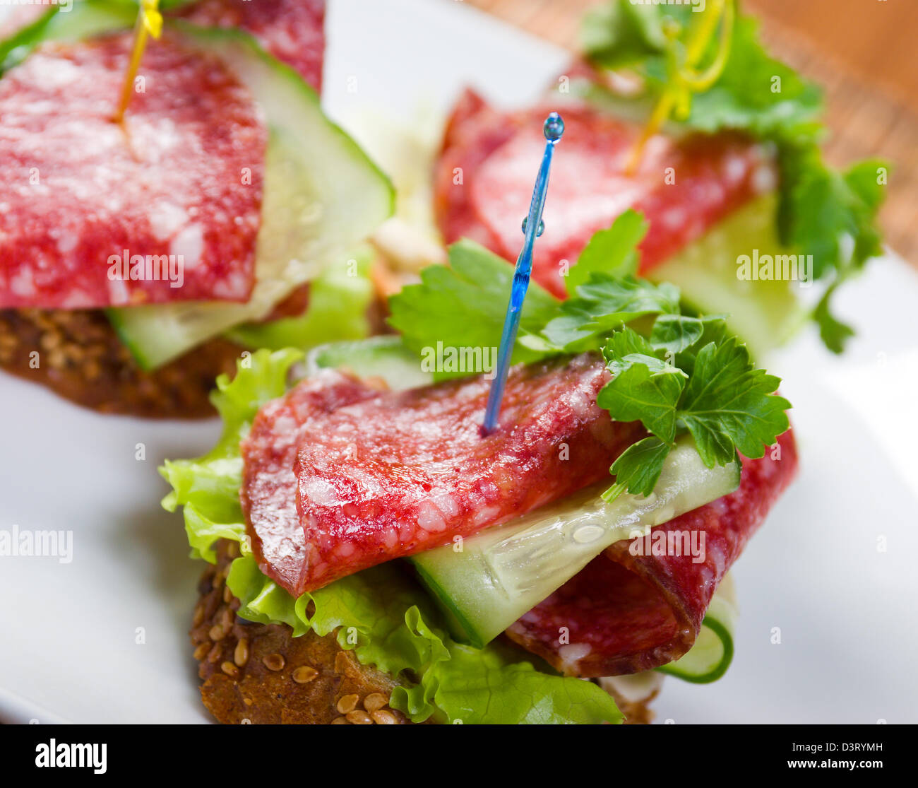 Canape with salami and cucumber. Shallow depth-of-field Stock Photo - Alamy
