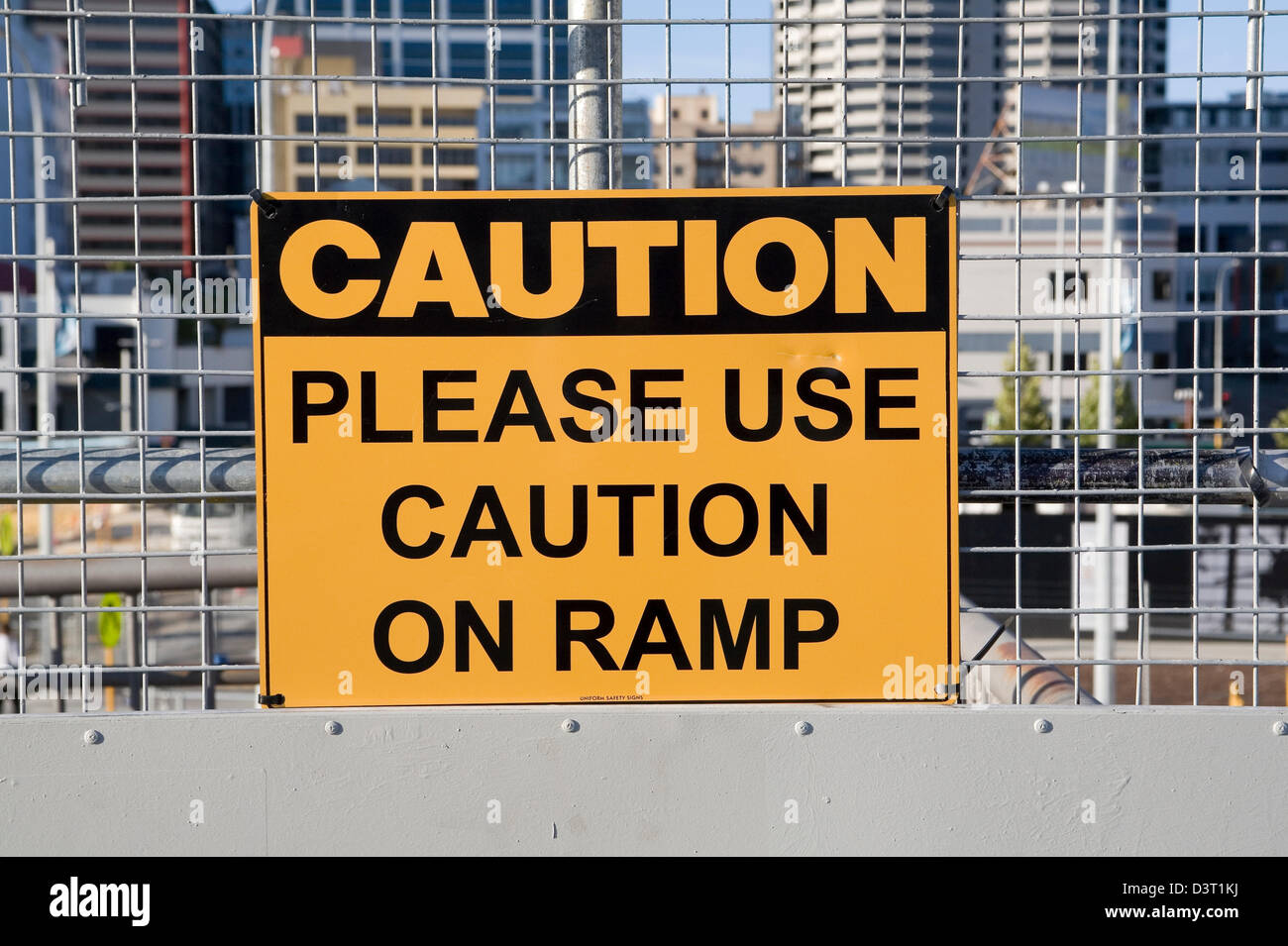 A sign advising pedestrians to use caution due to construction and ...