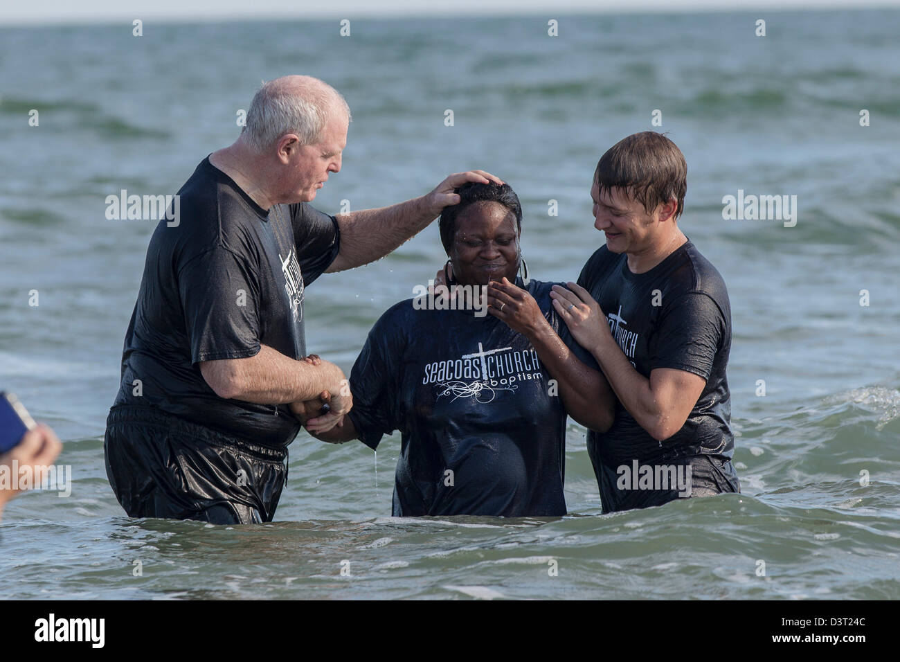 Members of the Christian Evangelical Seacoast Church perform baptism in ...