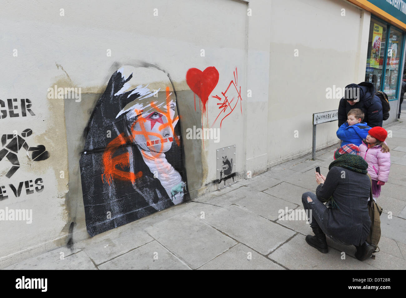 Wood Green, London, UK. 24th February 2013. People look at the Graffiti ...