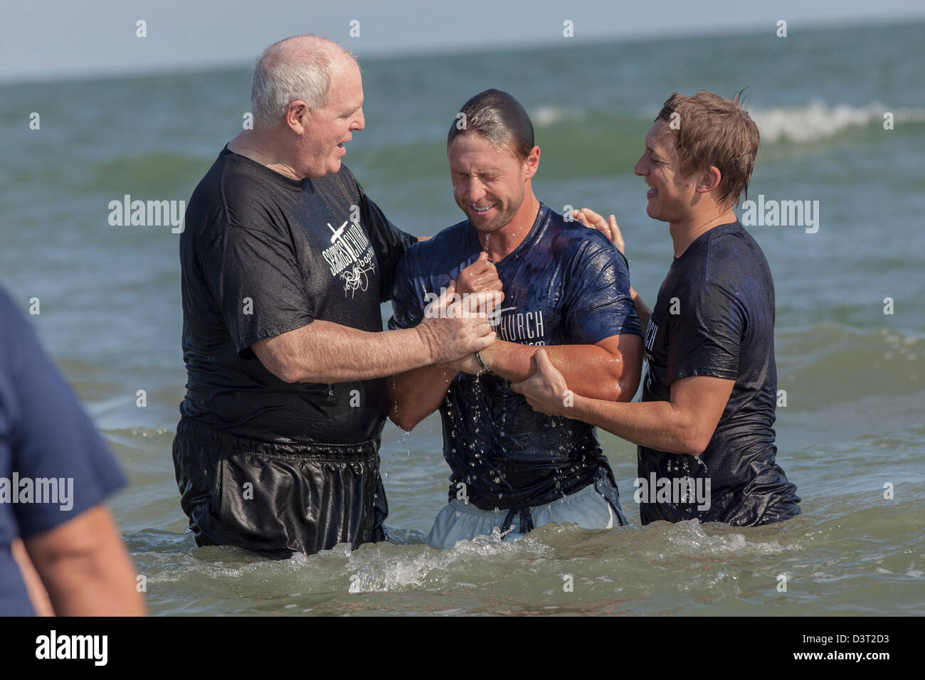 Members of the Christian Evangelical Seacoast Church perform baptism in ...