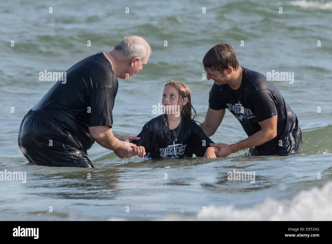 Members of the Christian Evangelical Seacoast Church perform baptism in ...