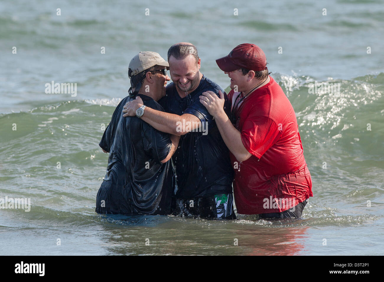 Members of the Christian Evangelical Seacoast Church perform baptism in ...