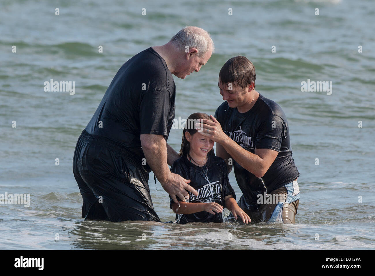 Members of the Christian Evangelical Seacoast Church perform baptism in ...