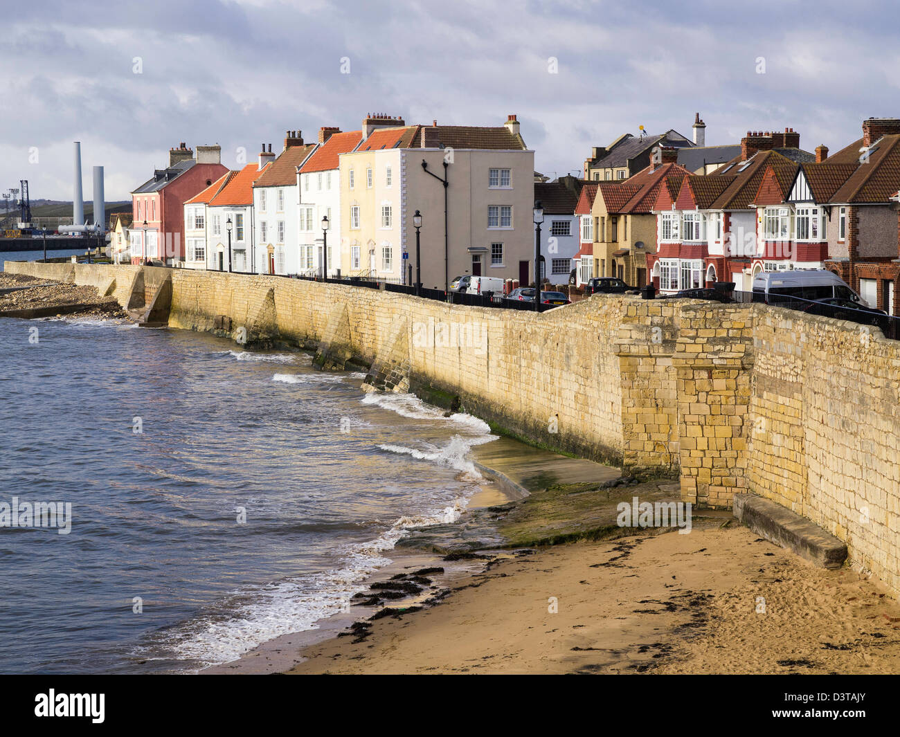 Houses protected by a sea wall originally built in medieval times at ...