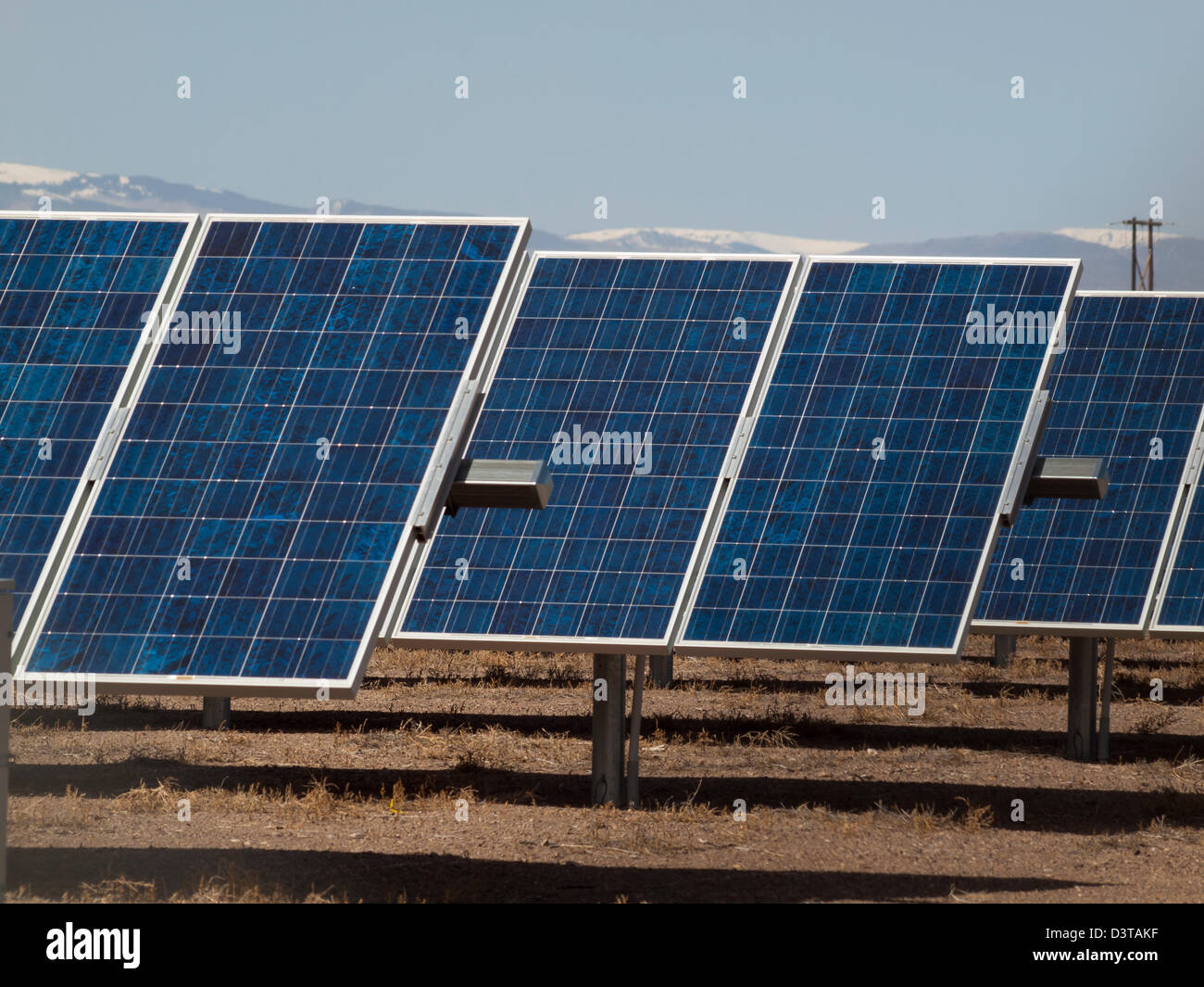 A series of large solar panels forms a symmetrical line at a power ...