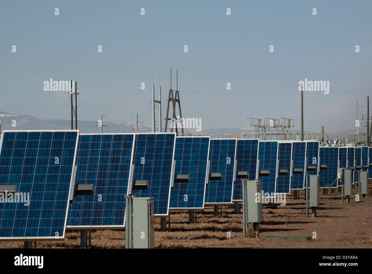 A series of large solar panels forms a symmetrical line at a power ...