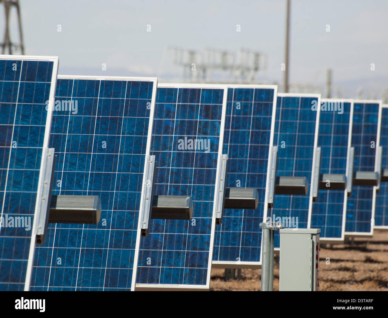A series of large solar panels forms a symmetrical line at a power ...