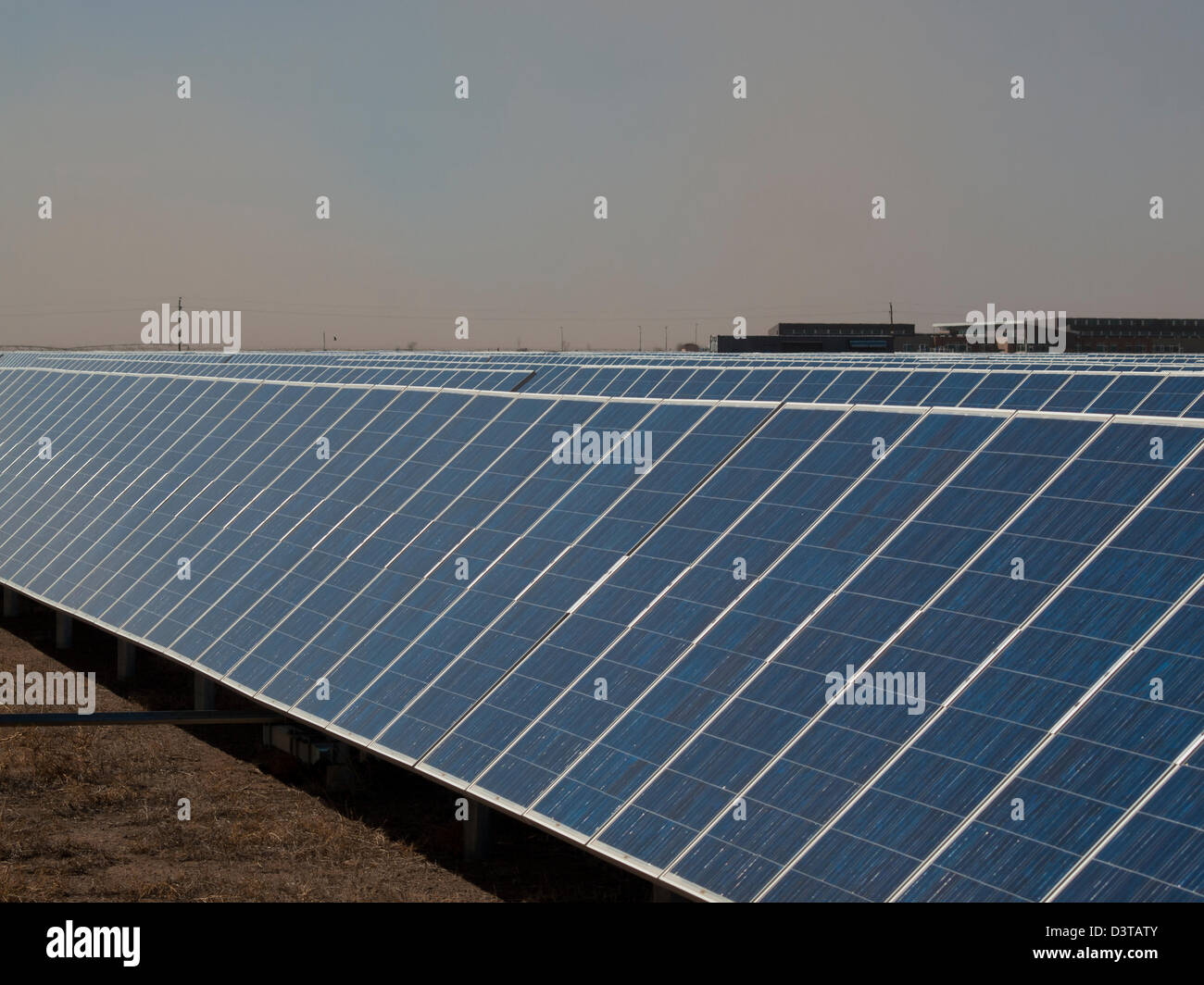 A series of large solar panels forms a symmetrical line at a power ...