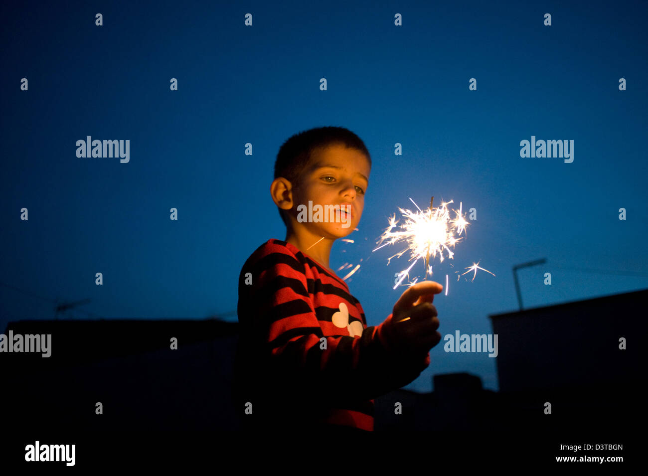 Child with a burning flare at night Stock Photo - Alamy