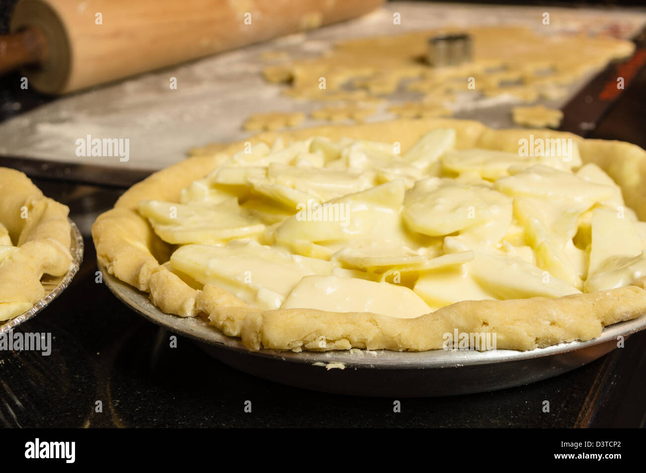 An unbaked apple pie shell with apple slices ready for the oven Stock ...