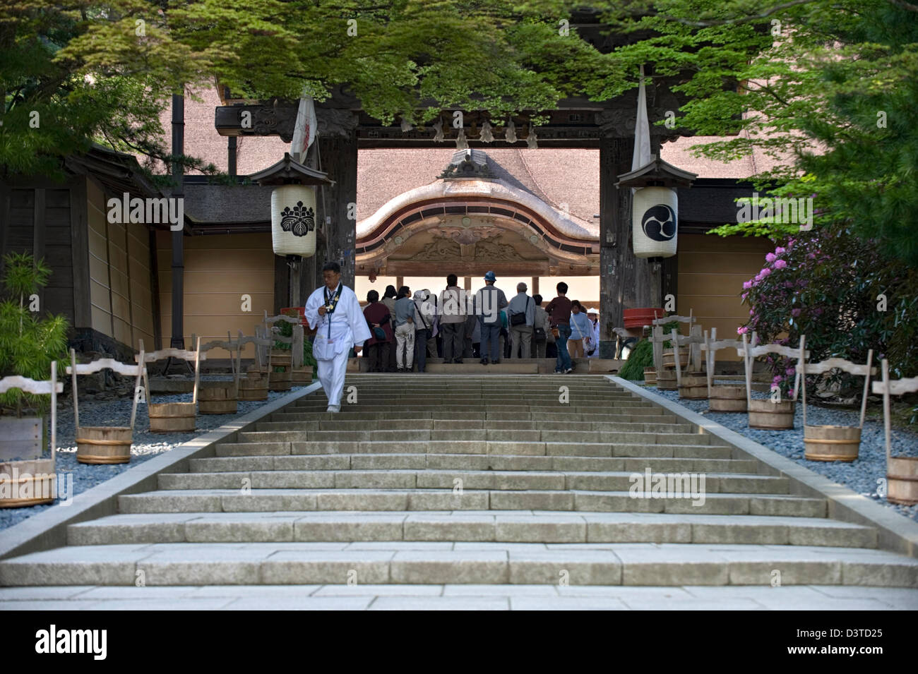 Main entry gate at top of stone steps lined with wooden water buckets ...