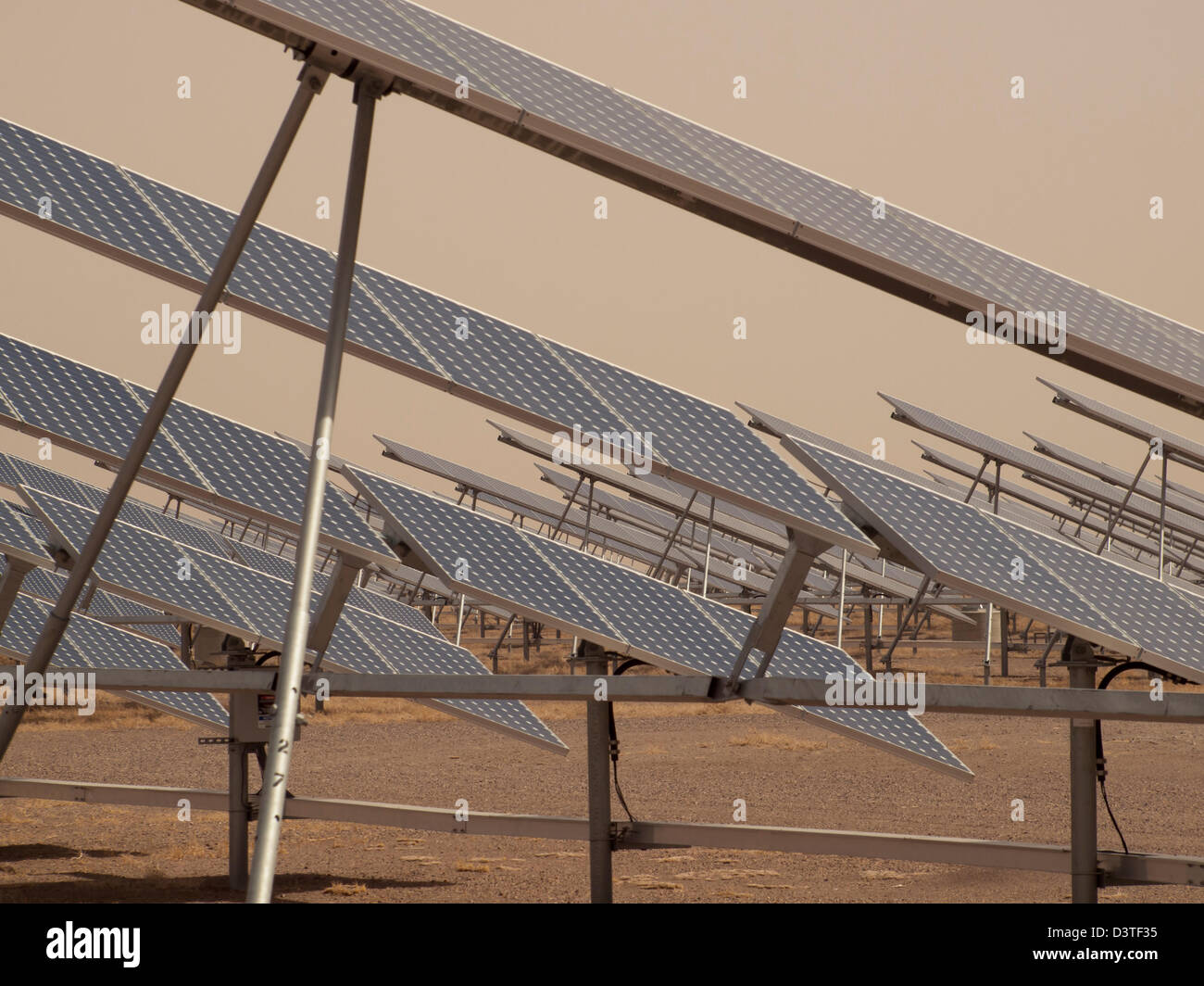 A series of large solar panels forms a symmetrical line at a power ...