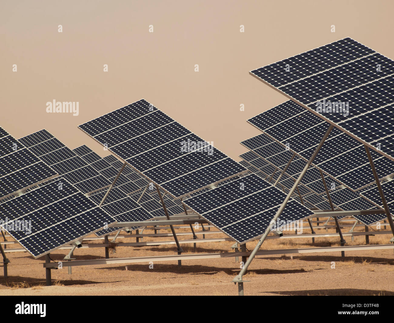 A series of large solar panels forms a symmetrical line at a power ...