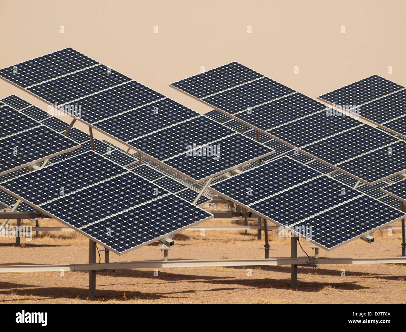 A series of large solar panels forms a symmetrical line at a power ...