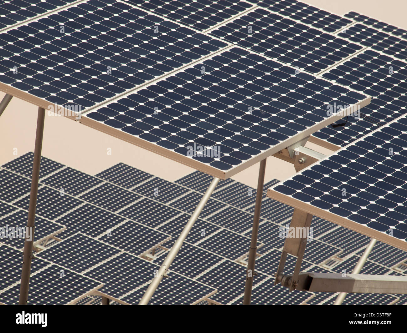 A series of large solar panels forms a symmetrical line at a power ...