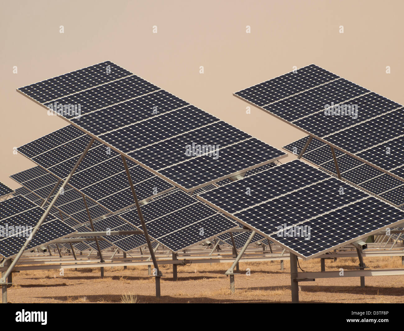 A series of large solar panels forms a symmetrical line at a power ...