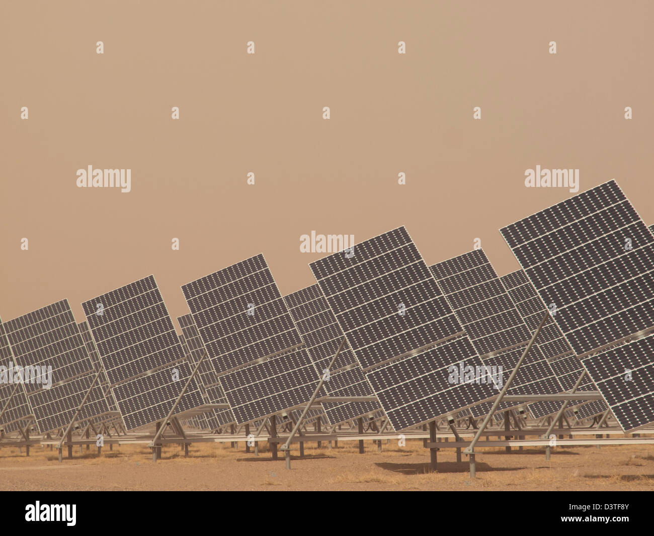 A series of large solar panels forms a symmetrical line at a power ...