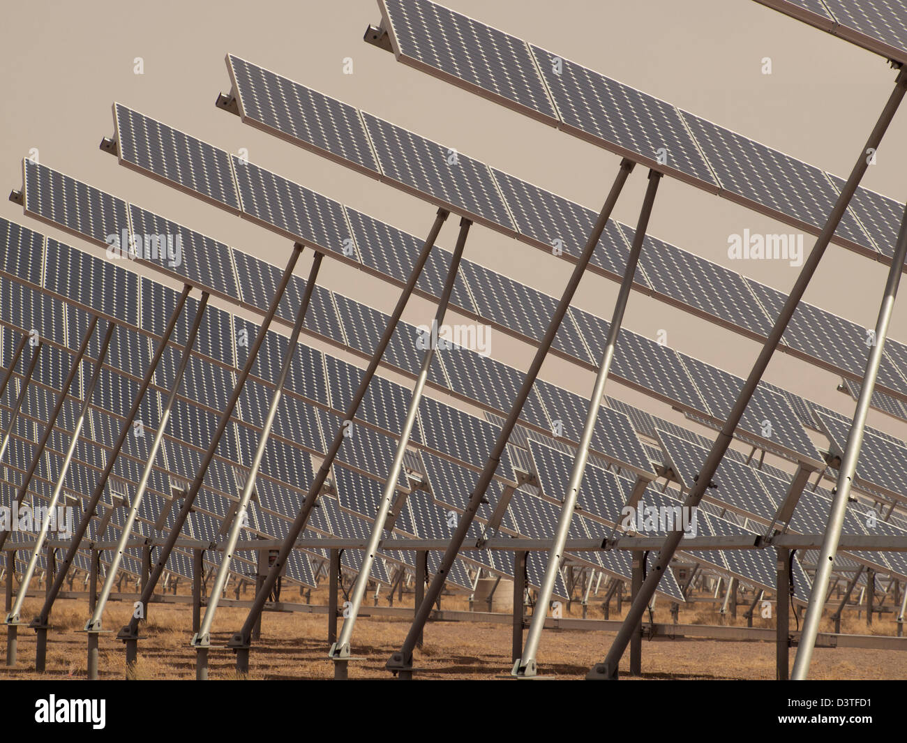A series of large solar panels forms a symmetrical line at a power ...
