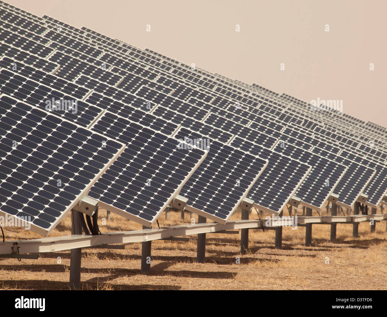 A series of large solar panels forms a symmetrical line at a power ...