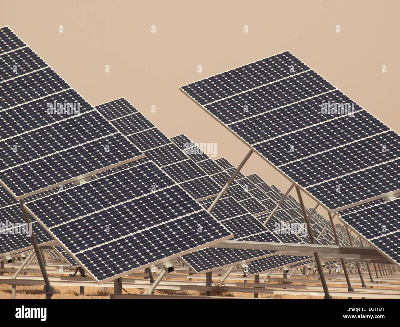 A series of large solar panels forms a symmetrical line at a power ...