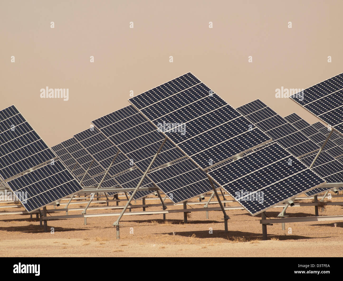 A series of large solar panels forms a symmetrical line at a power ...