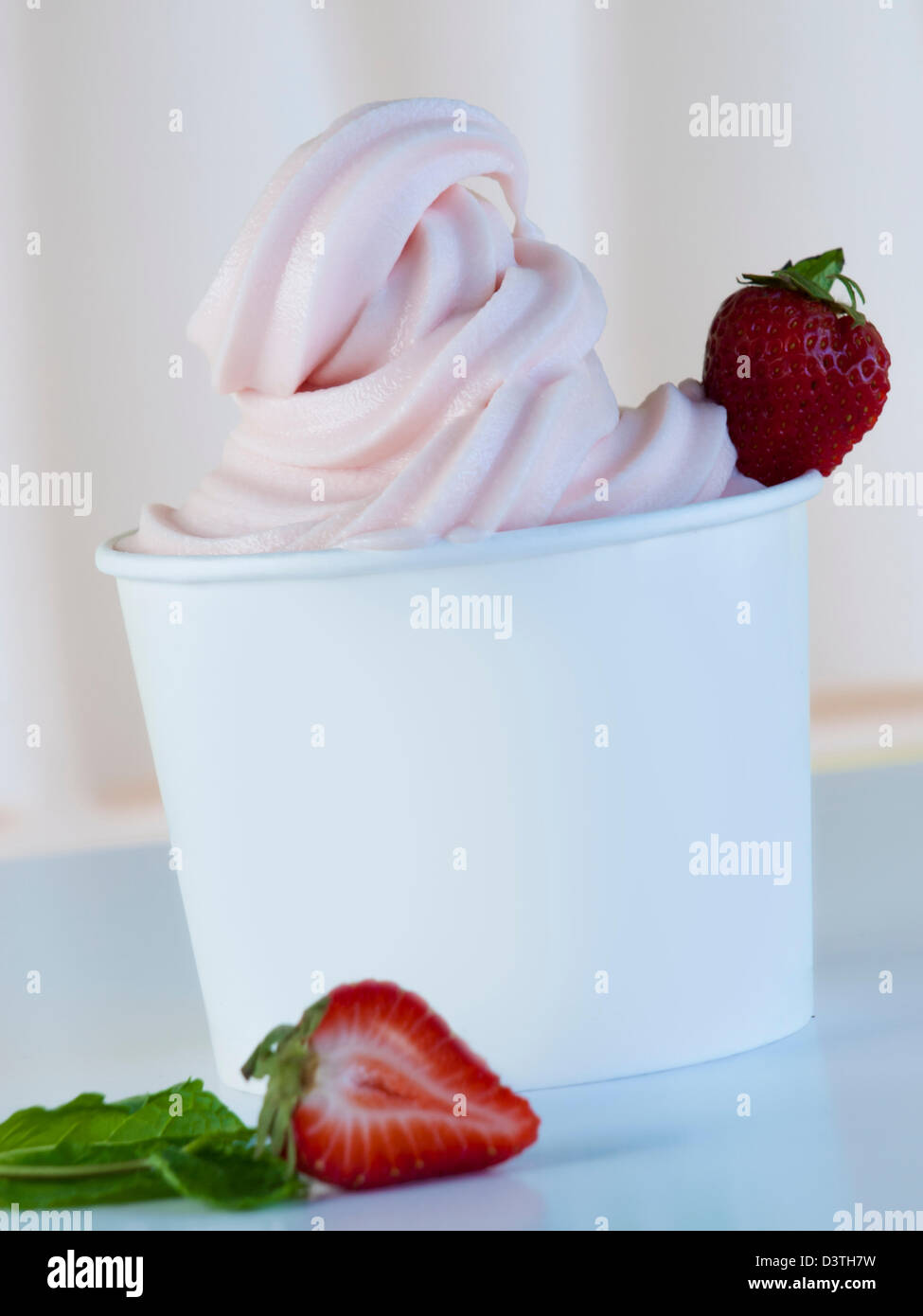 Cup of strawberry frozen yogurt or soft serve ice cream with fresh ...