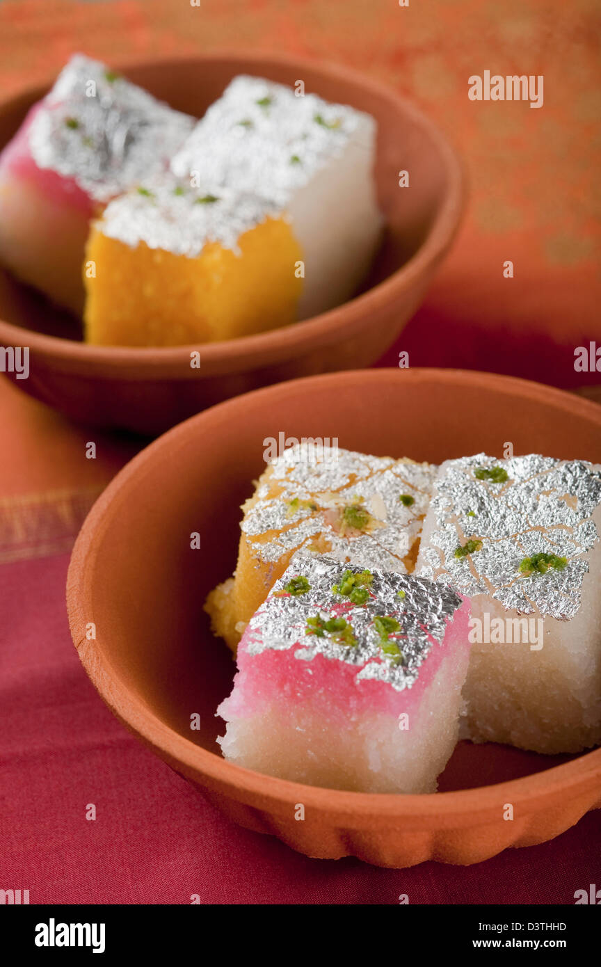 Colorful coconut burfi in bowls Stock Photo - Alamy