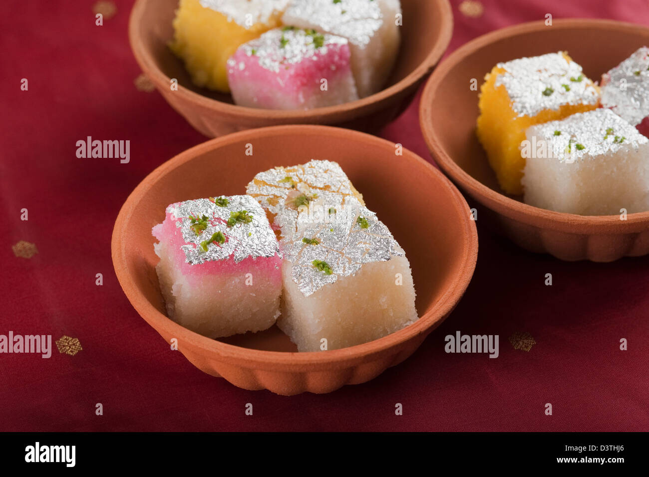 Colorful coconut burfi in bowls Stock Photo - Alamy