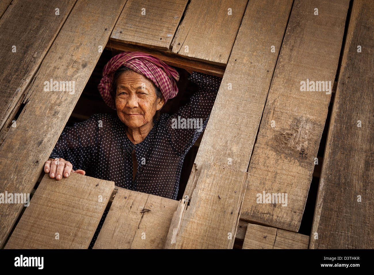 Elderly woman looking through the window, Cambodia Stock Photo - Alamy