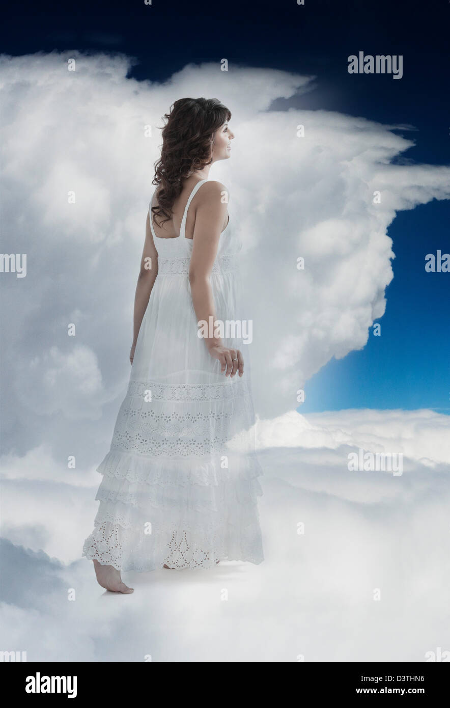 Woman walking in clouds Stock Photo - Alamy