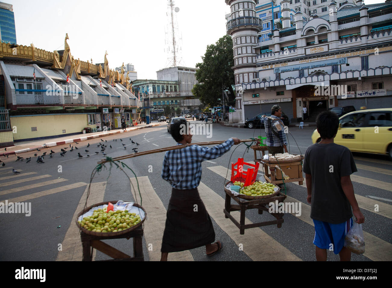 Street vendor crossing the road near the Sule Paya Stock Photo - Alamy