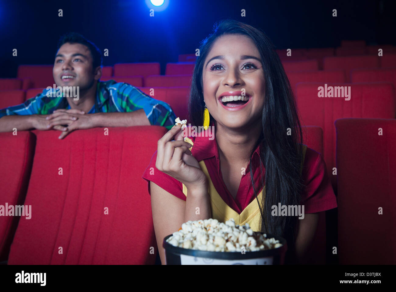 Youngsters watching movie in a cinema hall Stock Photo - Alamy