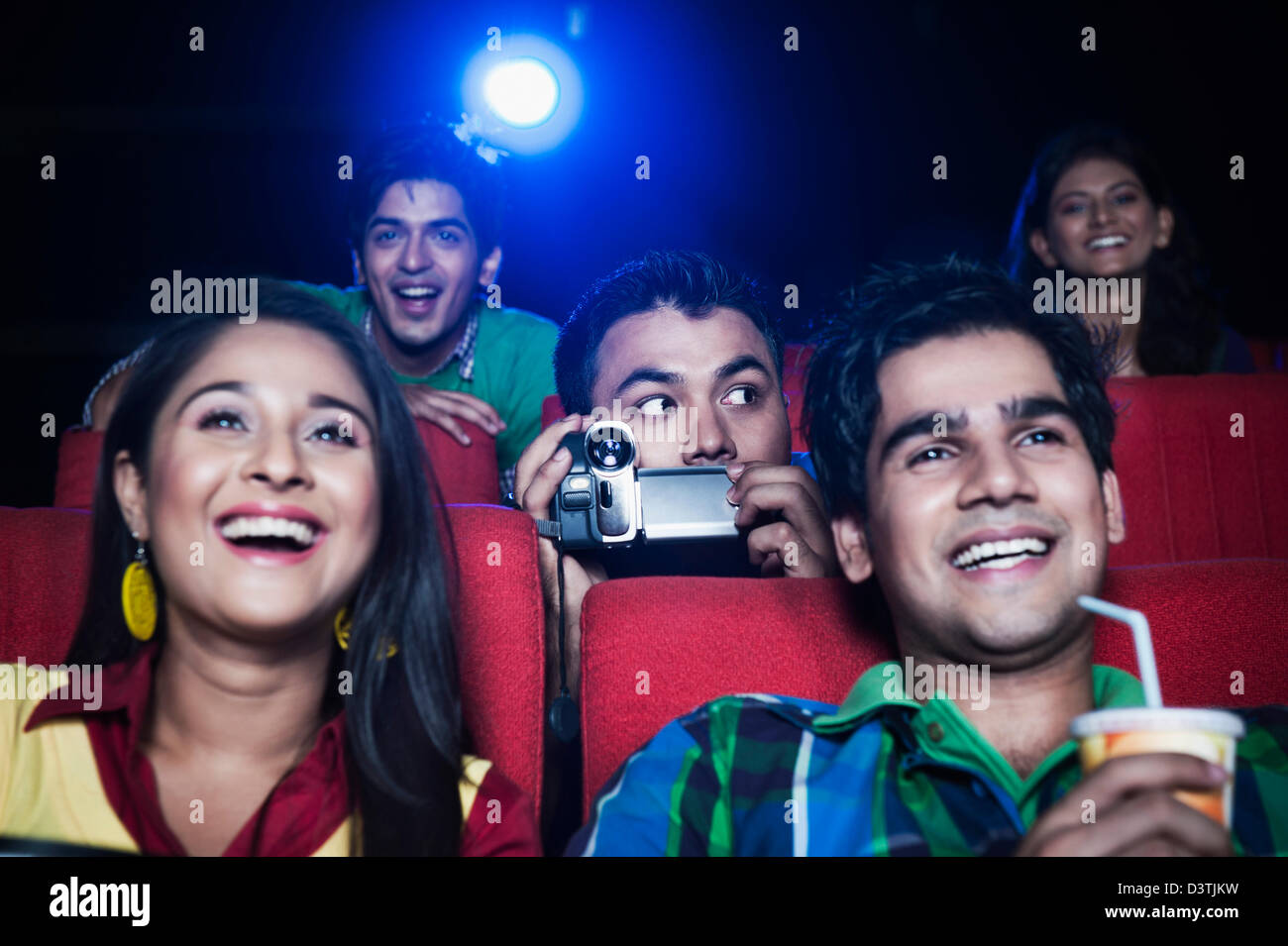 Man using video recorder in a cinema hall Stock Photo - Alamy