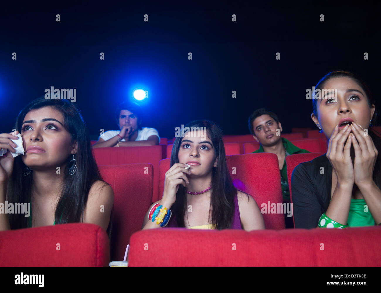 Women crying while watching movie in a cinema hall Stock Photo - Alamy