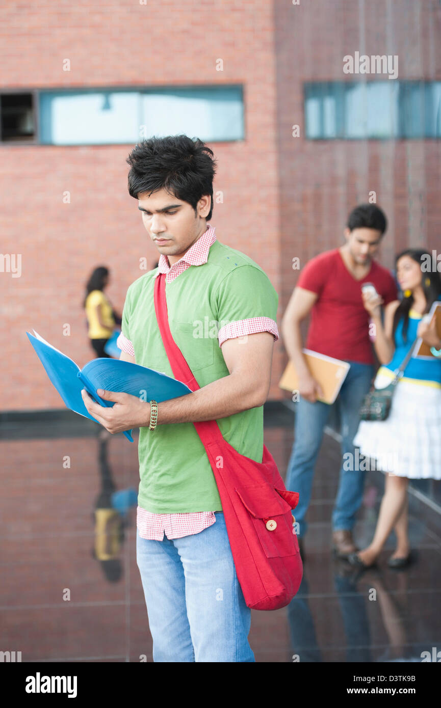 University student reading notes in university campus Stock Photo - Alamy