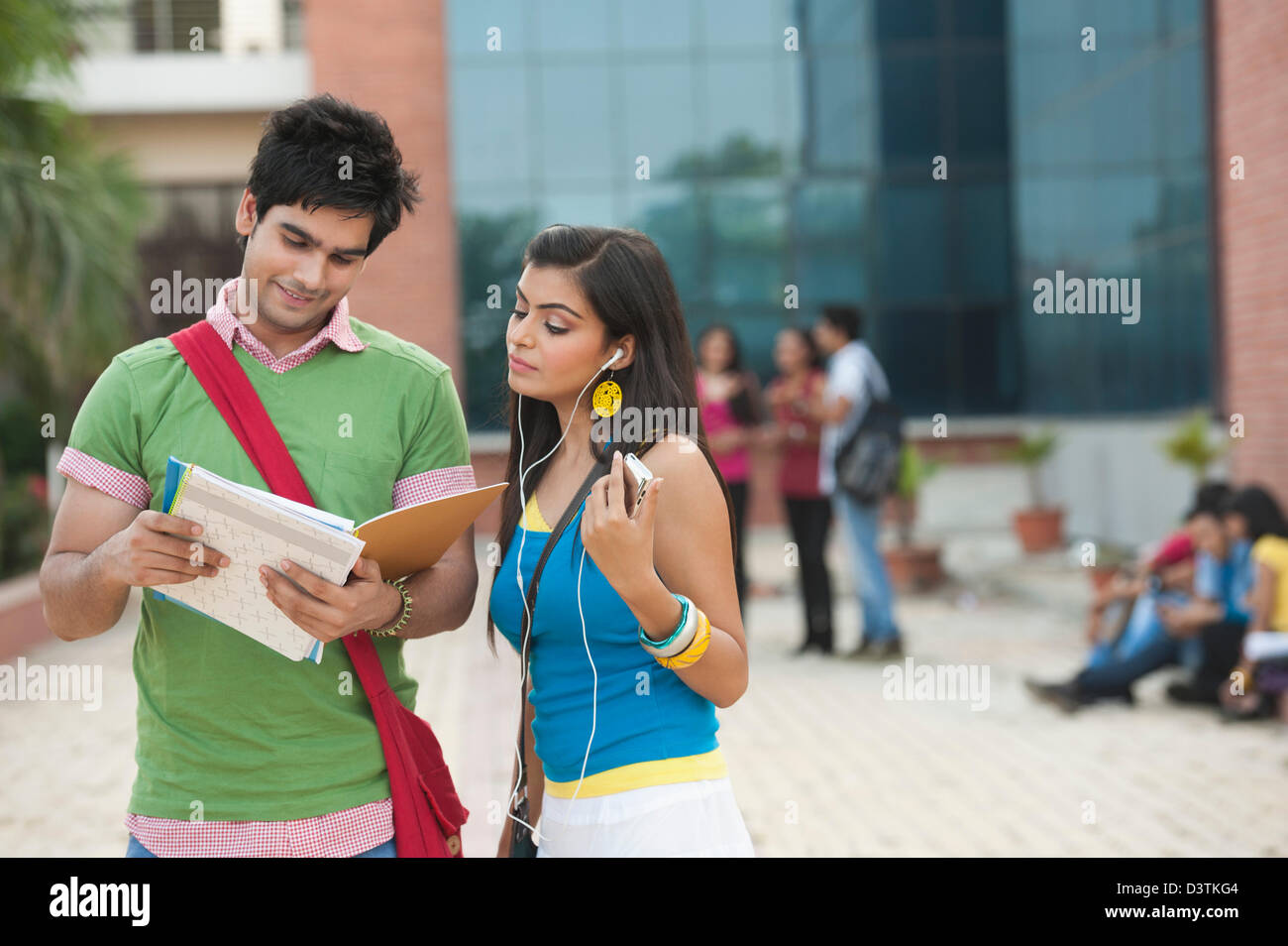 University students reading a book in university campus Stock Photo - Alamy