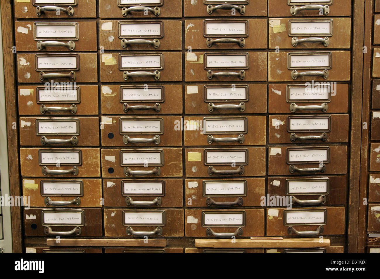 The picture shows a card-index cabinet with labelled drawers at the ...