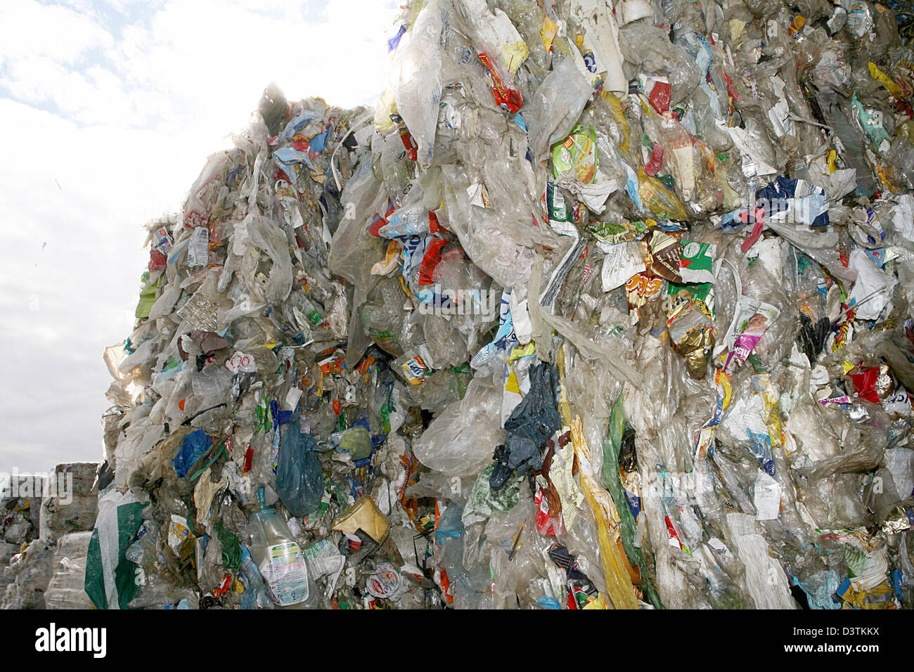 The picture shows bales of pressed paper and plastic waste stacked at ...