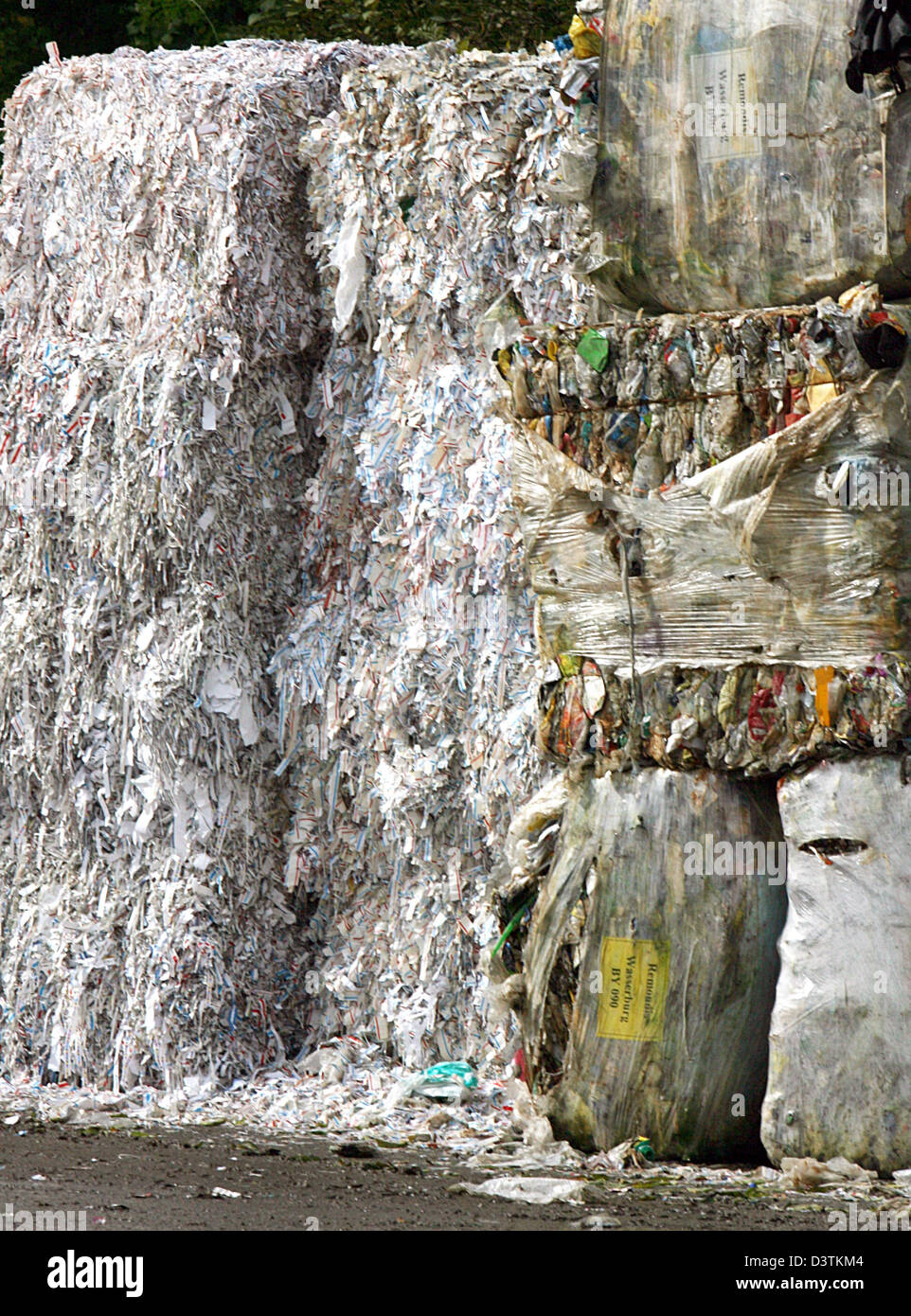 The picture shows bales of pressed paper and plastic waste stacked at ...