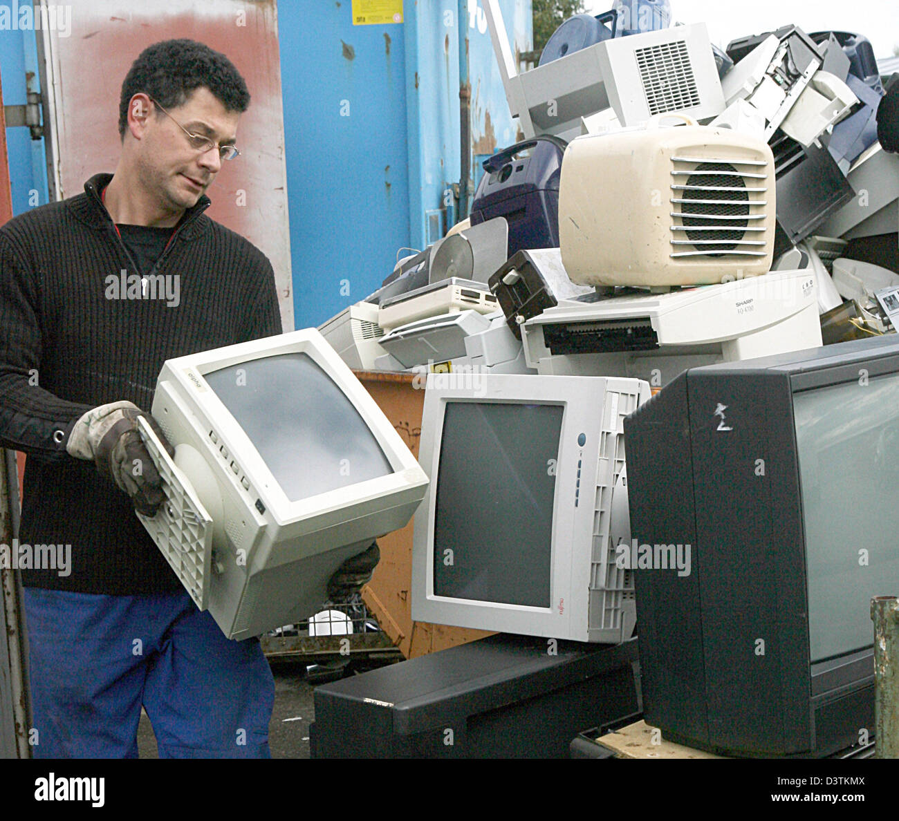 A worker sorts old tv sets and computer screens at the Vivo recycling ...