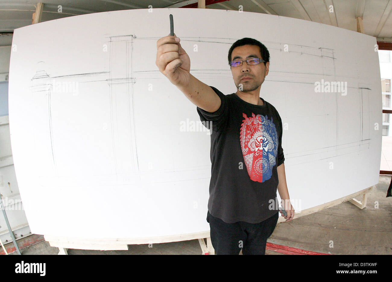 The Chinese artist Meng Huan paints in a glass container in front of ...